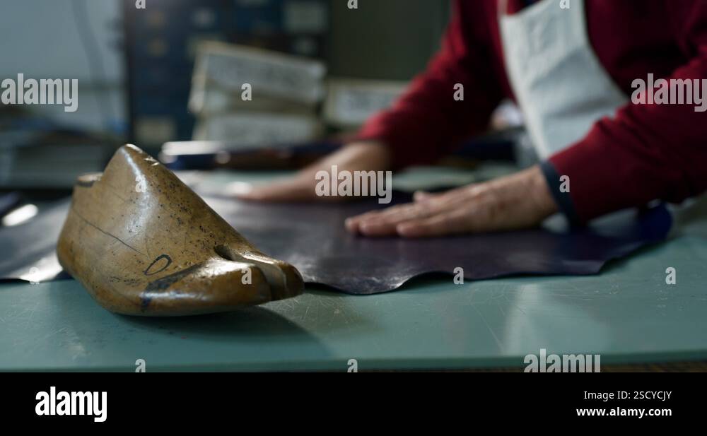 Close up of a shoemaker is working a fabric in a shoe factory Stock ...
