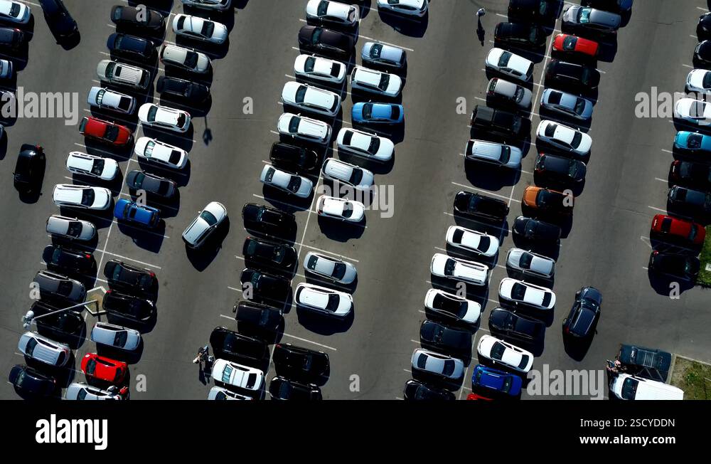 A view from above to the process of car parking. Heavy traffic in the ...