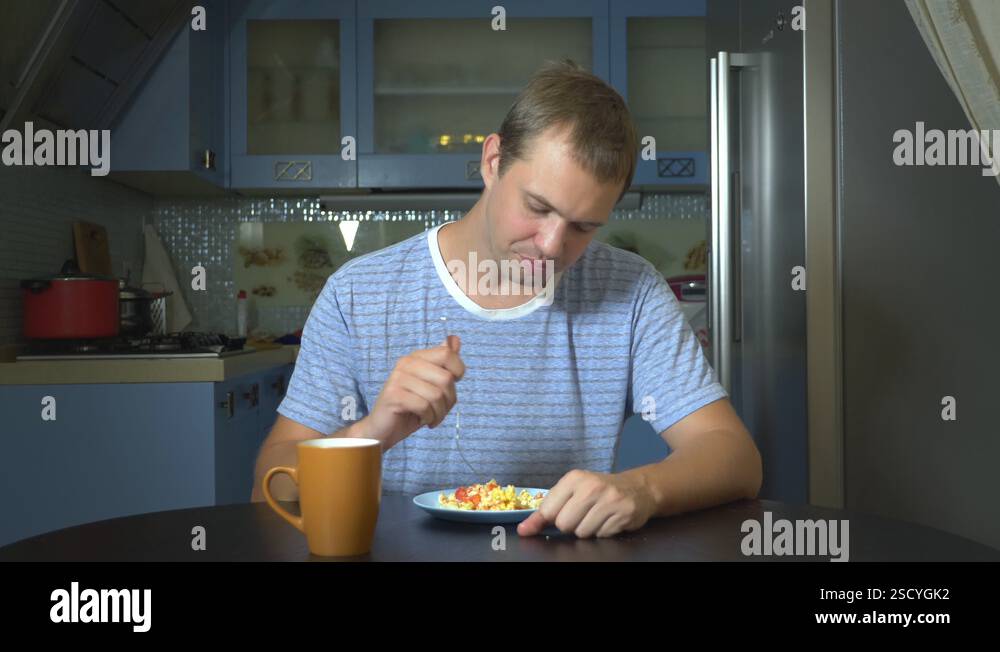 diet concept, tasteless food. Frustrated and annoyed man eating food ...