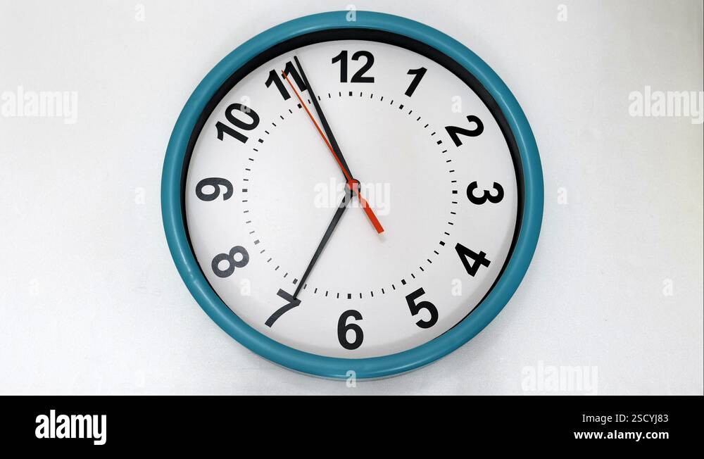 The White Clock With Black And Red Arrows Shows The Time Seven Hours ...