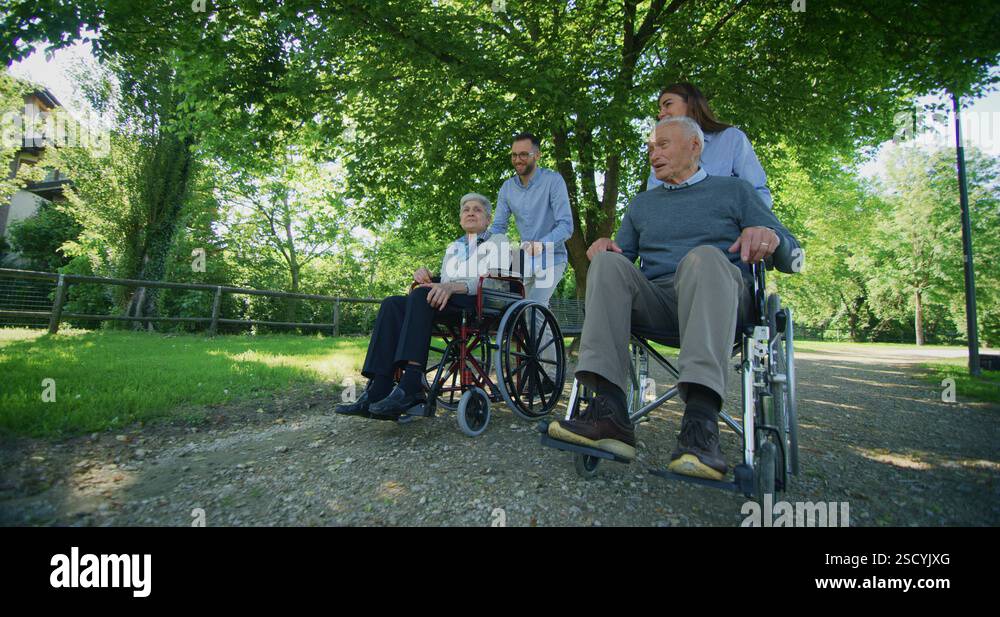 Grandchildren and their grandparents both in a wheelchair are having ...