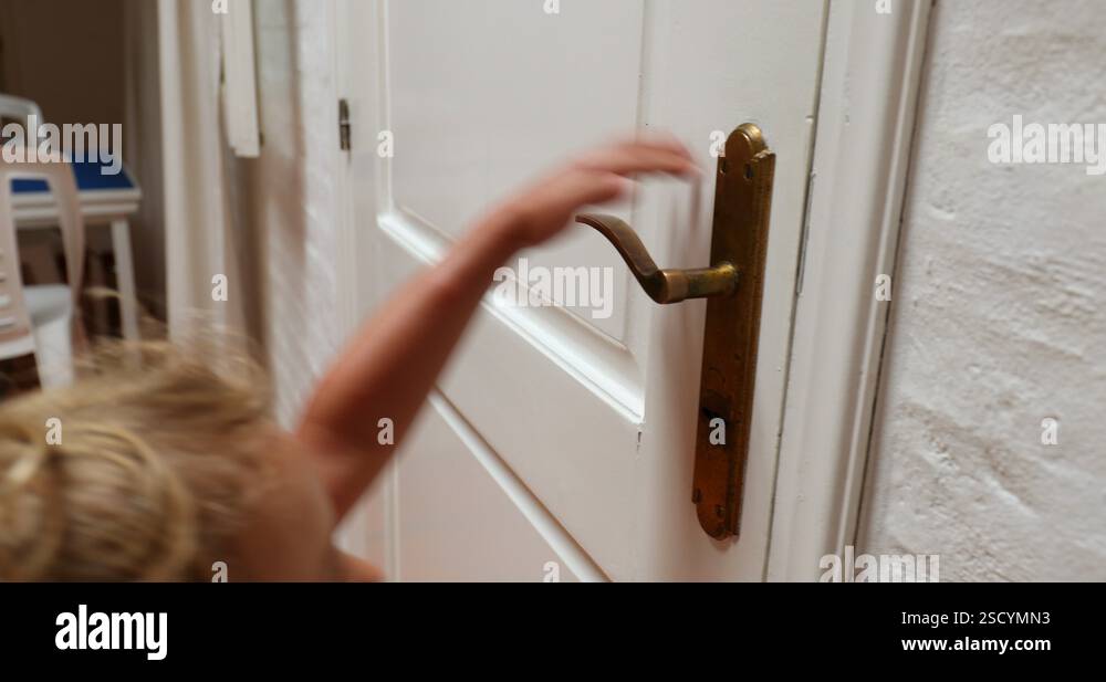 Infant boy opening and closing house front door Stock Video Footage - Alamy