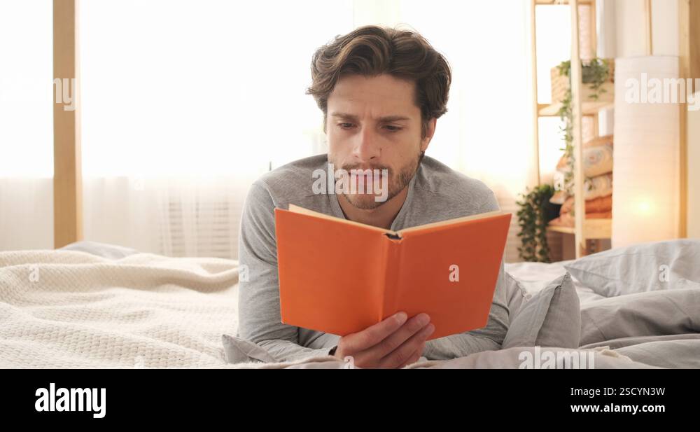 Relaxed man reading a book in the morning Stock Video Footage - Alamy