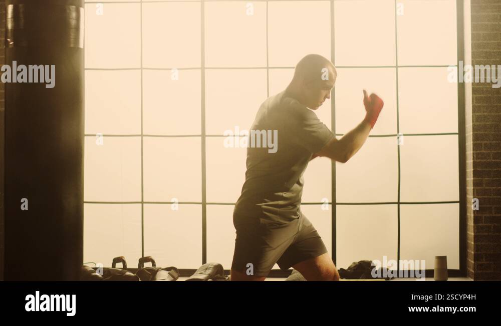 Strong and Handsome Male Boxer is Working Out in a Loft Gym with Big ...