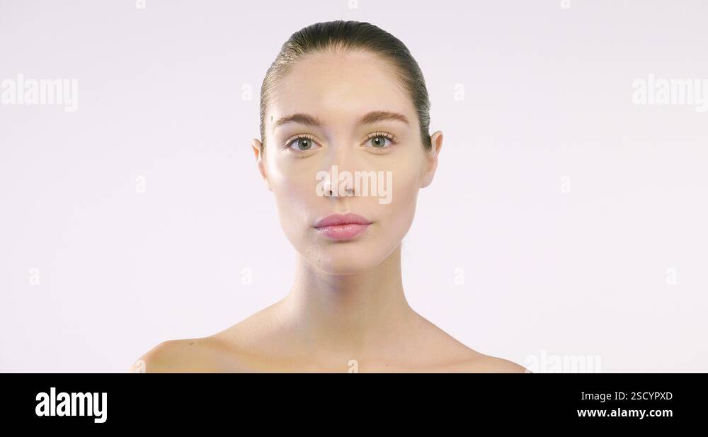 An young woman with perfect skin clean face is looking in camera Stock ...
