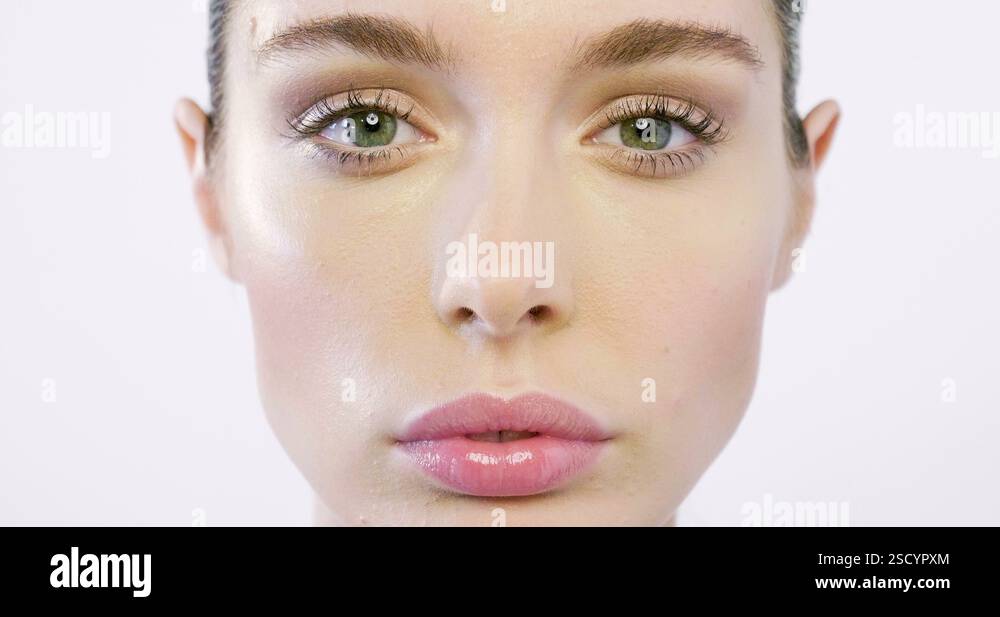 An young woman with perfect skin clean face is looking in camera Stock ...