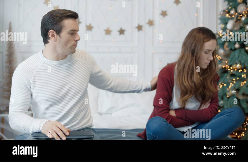 Handsome man saying sorry to woman in luxury house. Sad woman feeling ...