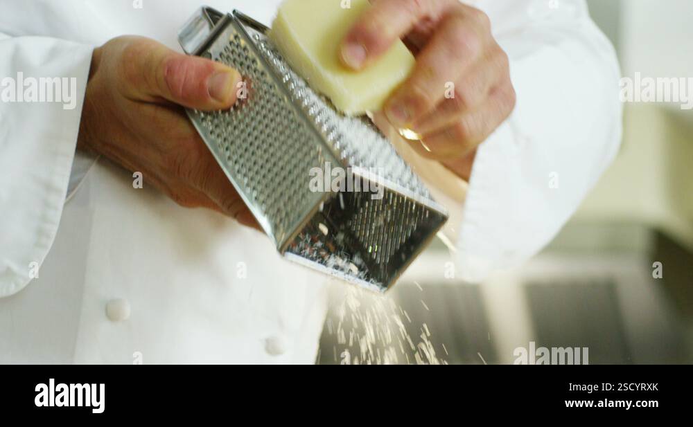 A cook grater Parmesan cheese on the plate Stock Video Footage - Alamy