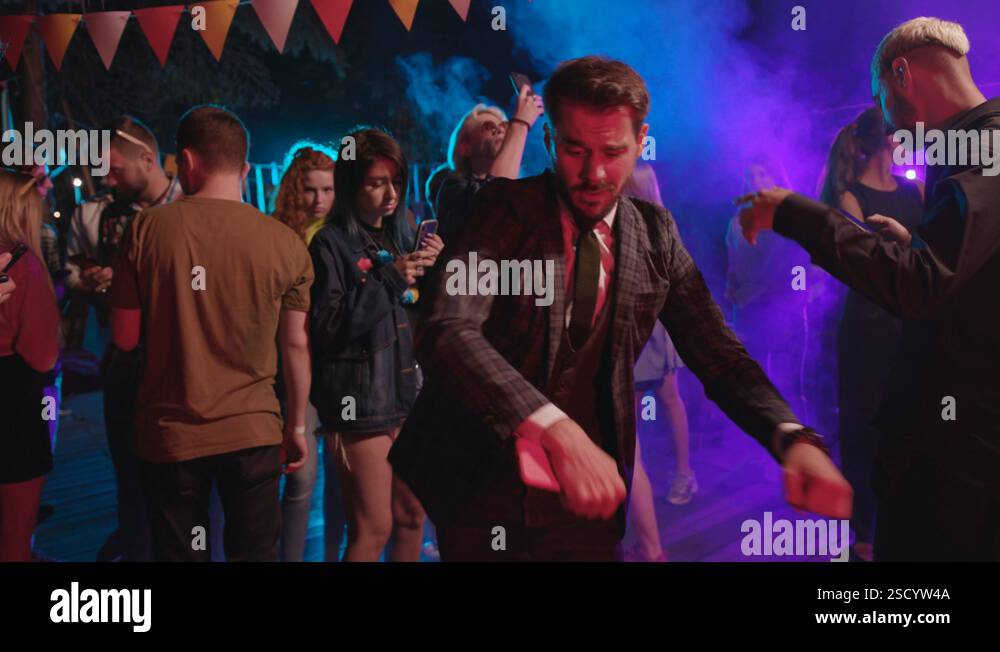 Crazy young businessman rocking off on modern night party. Young people ...