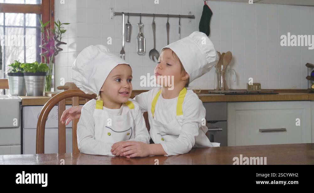 Portrait of two sisters dressed as chefs are having a lot of fun in the ...