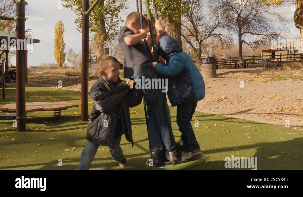 kids playing at the park in the fall dad trys to help Stock Video ...