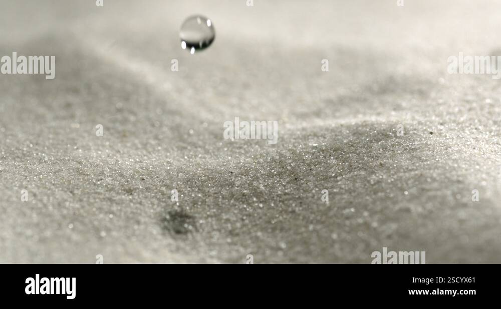 A drop of water is falling in slow motion on the sand Stock Video ...