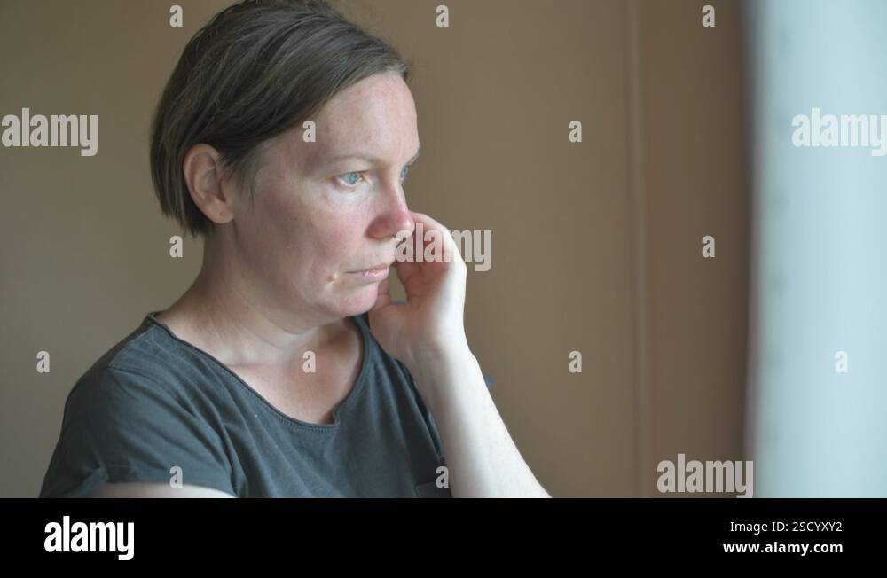 Worried woman waiting by the window Stock Video Footage - Alamy