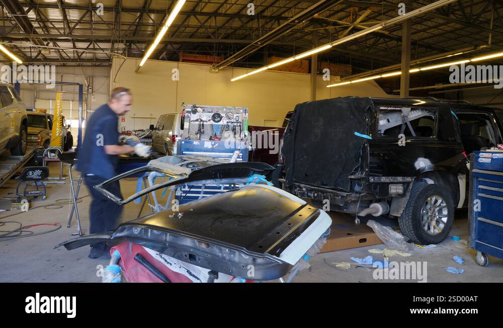 Time lapse automotive body man replacing a door skin in a repair shop ...