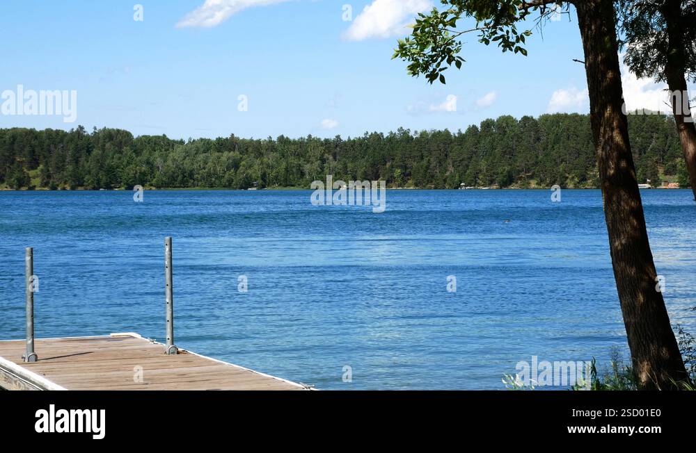 Beautiful lake in Minnesota with blue sky and water and a boat dock and ...