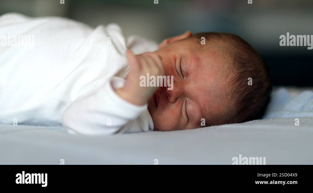 Baby newborn close-up face waking up and opening eyes Stock Video ...