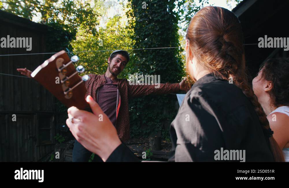 A woman playing the balalaika and a man dancing folklore dancing near ...