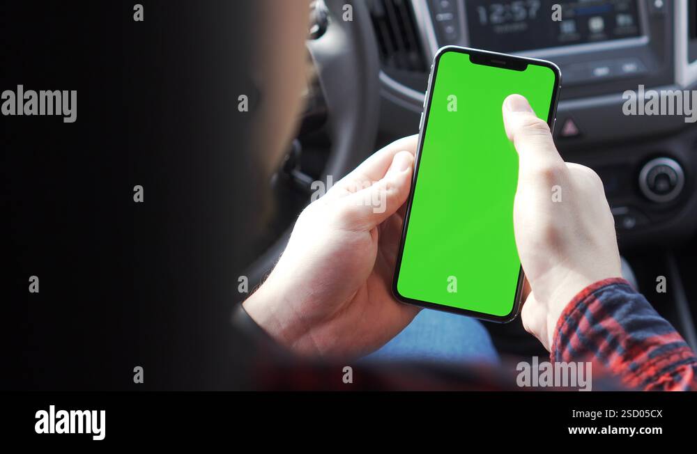 The guy in the car holding phone with green screen and poking ...