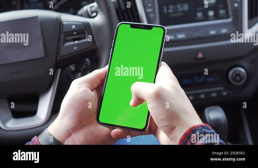 The guy in the car holding phone with green screen and poking ...