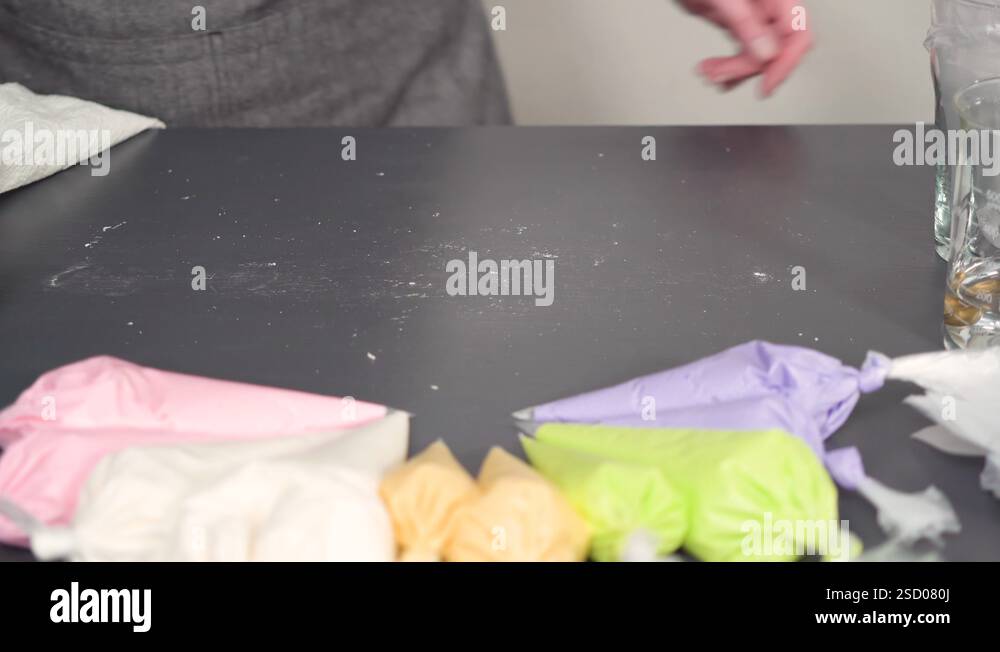 Mixing in food coloring into the royal icing to decorate sugar cookies ...