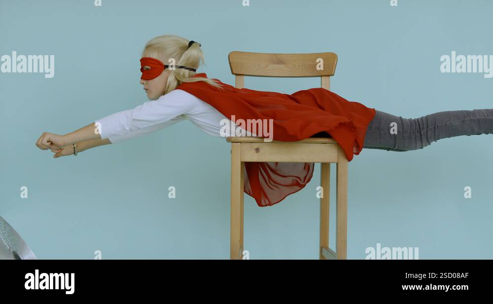 1000 FPS Cute little Caucasian girl wearing superhero cape and mask ...