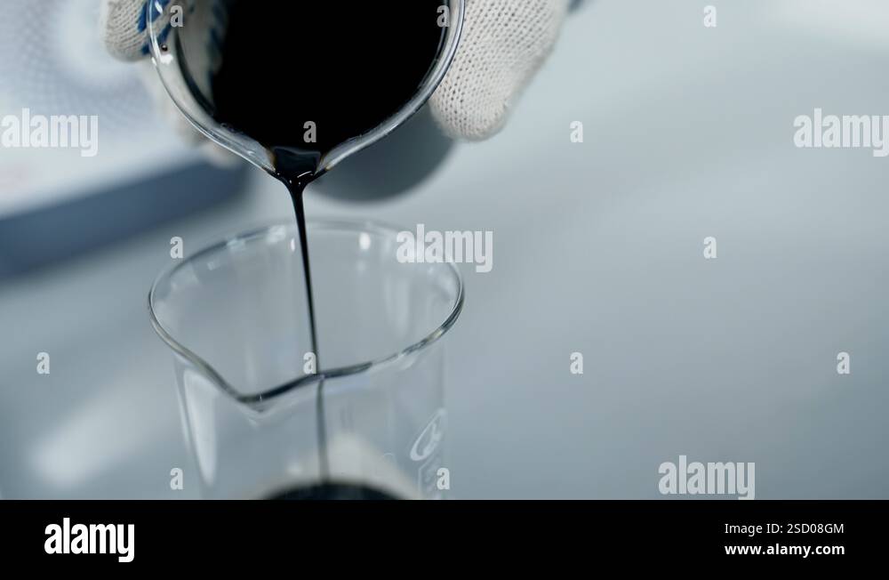 Raw oil sample research in laboratory. Scientist hand glass of black ...
