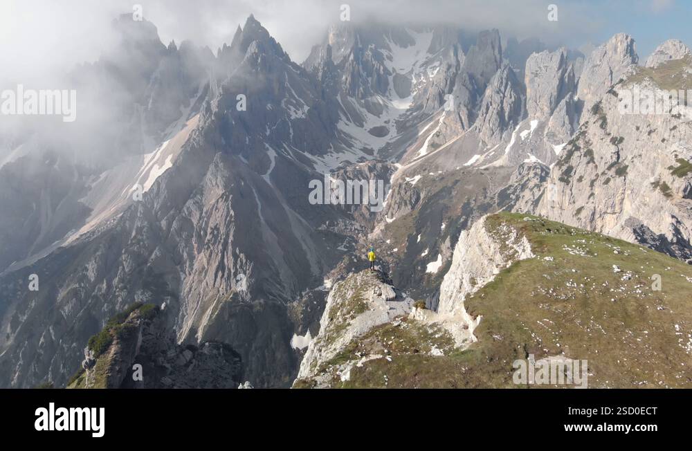 Aerial Man Standing On Mountain Edge At Tre Cime di Lavaredo In ...