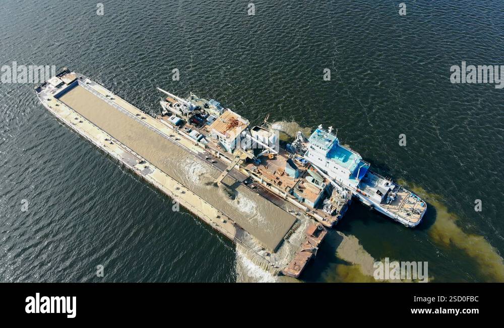 Boats and a barge extract sand on water Stock Video Footage - Alamy