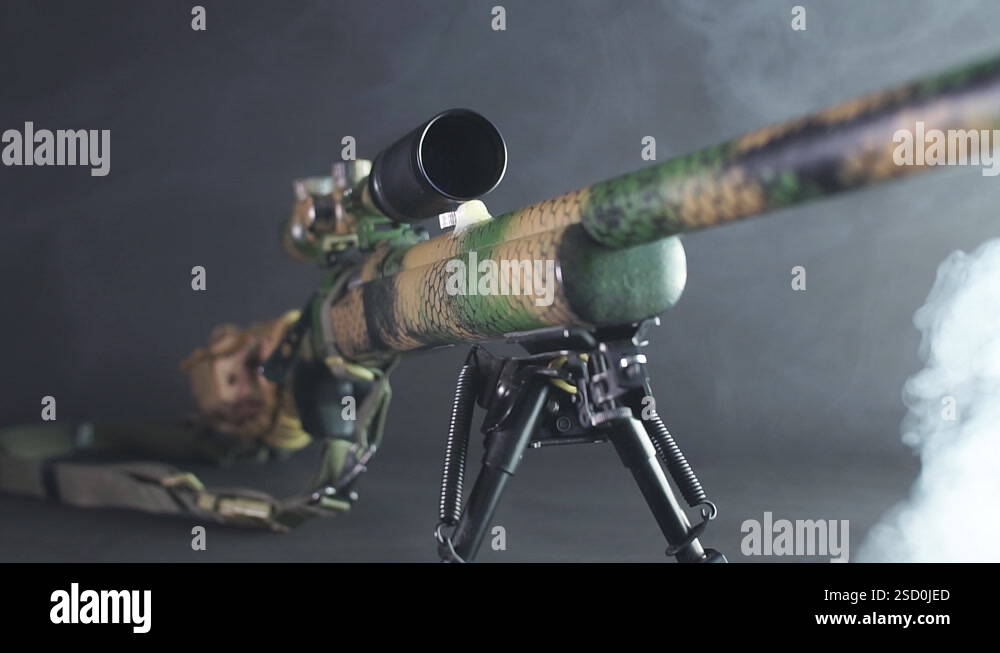 Slow plan of sniper rifle with silencer. Dark background and overhead ...