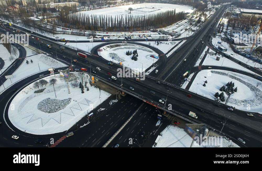 Freeway intersection in winter city. Drone of car traffic on snowy road ...