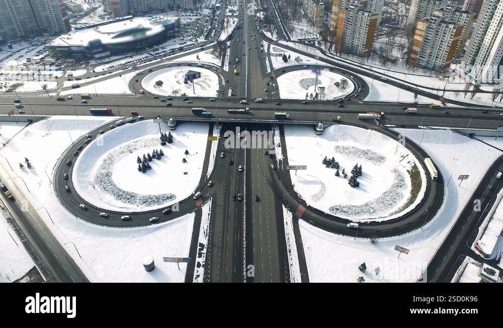 Cars traffic on highway junction in winter city. Aerial view freeway ...
