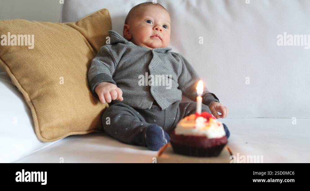 Celebrating baby first month of life with cupcake and candlelight Stock ...