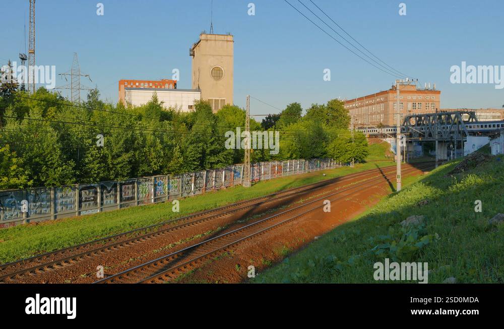 Electric train RZD passes under the overpass which also runs a commuter ...