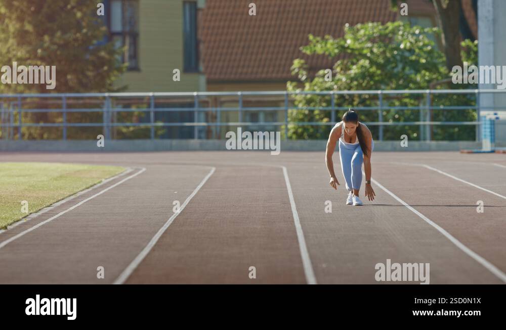 Beautiful Fitness Woman in Light Blue Athletic Top is Starting a Sprint ...