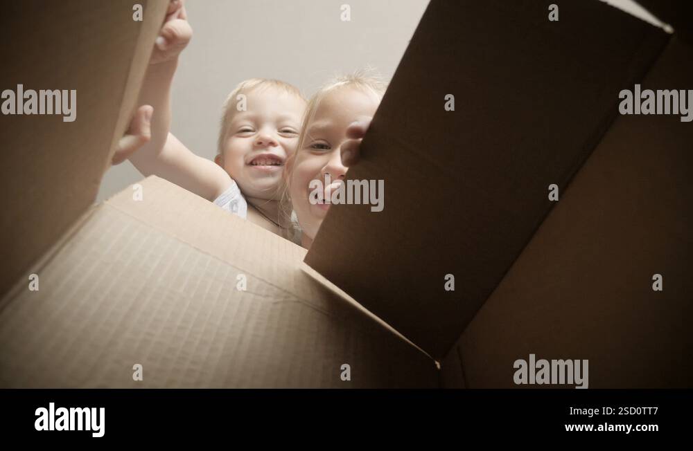 Two children looking into a box. Happy Children Opening Gifts Stock ...