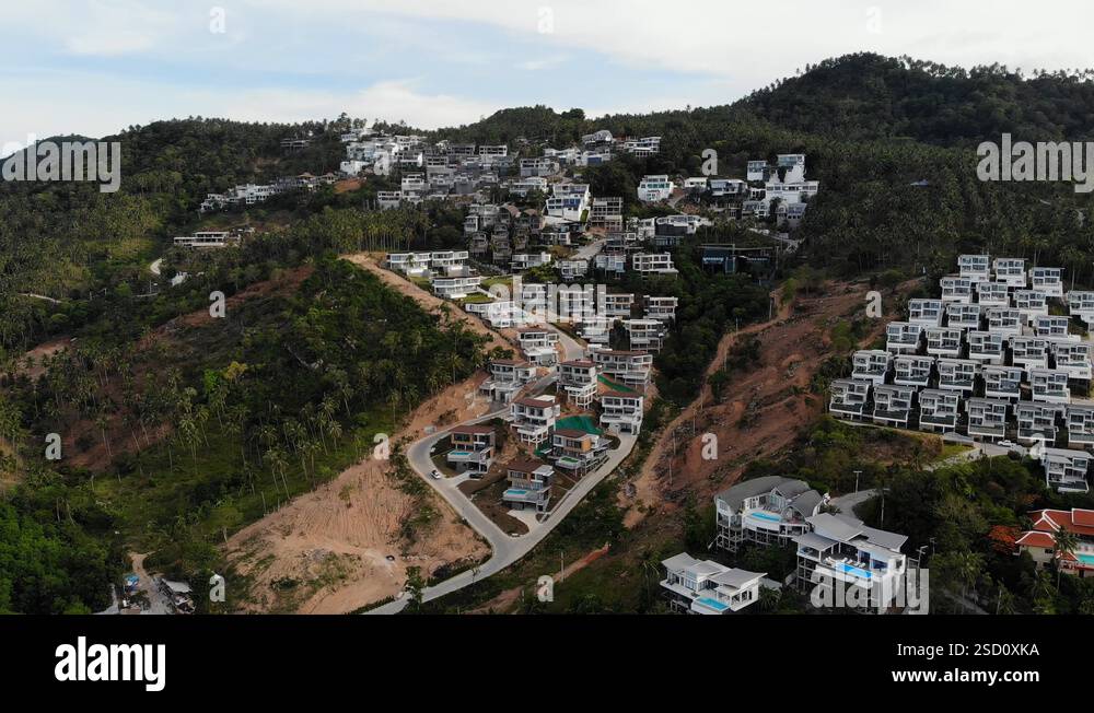 Tropical terrain covered with endangered forests and luxury villas ...