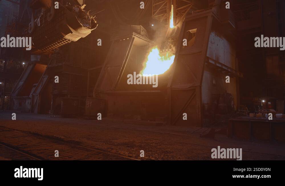 Iron Foundry. Opening of a steelmaking furnace for loading scrap metal ...