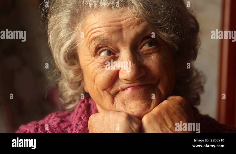 Smile and looking elderly wrinkled woman face with hands on chin in ...