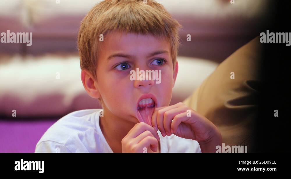 Kid hypnotized by TV screen watching movie on screen Stock Video ...