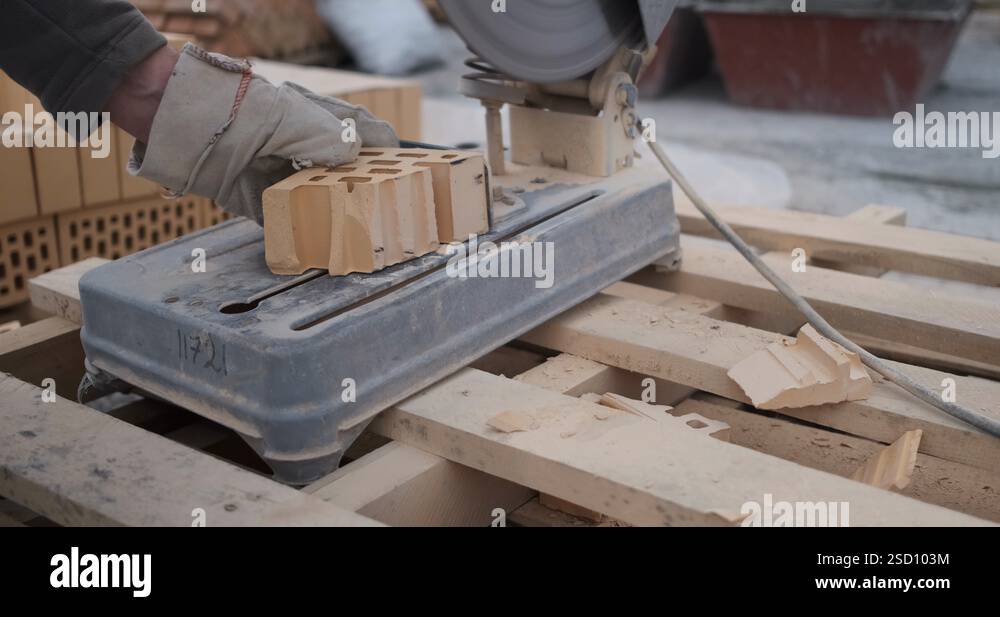 Using circular saw, bricklayer easily cuts brick into pieces, evens ...