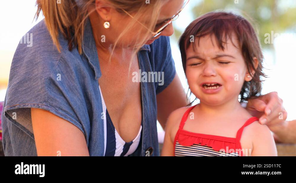 Upset little girl child crying and complaining mother hugging daughter ...