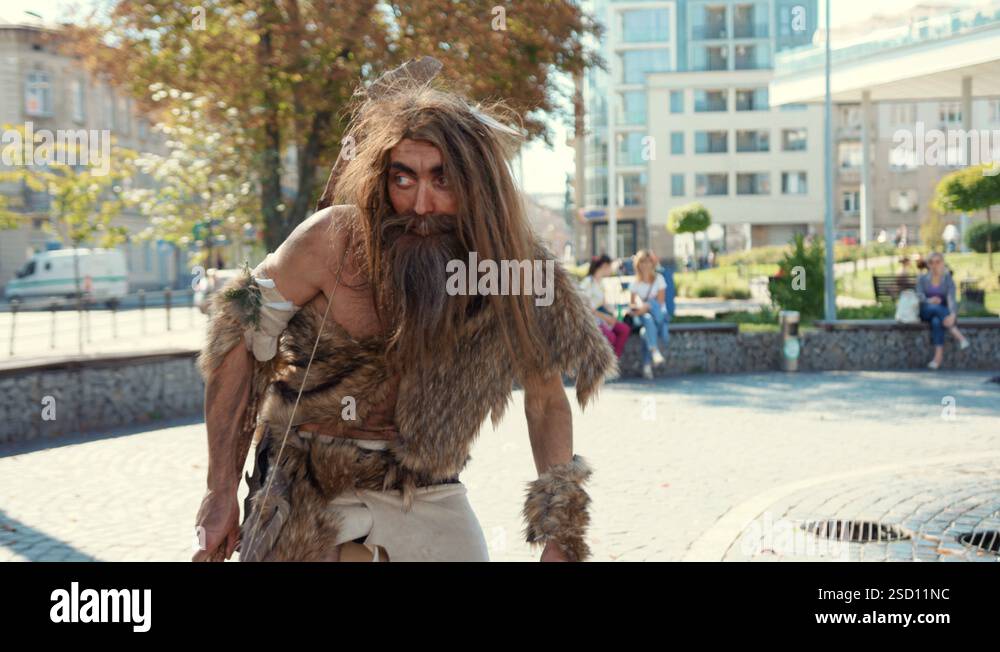 Primitive bowman of hunter-gatherers walking in slow motion exploring ...