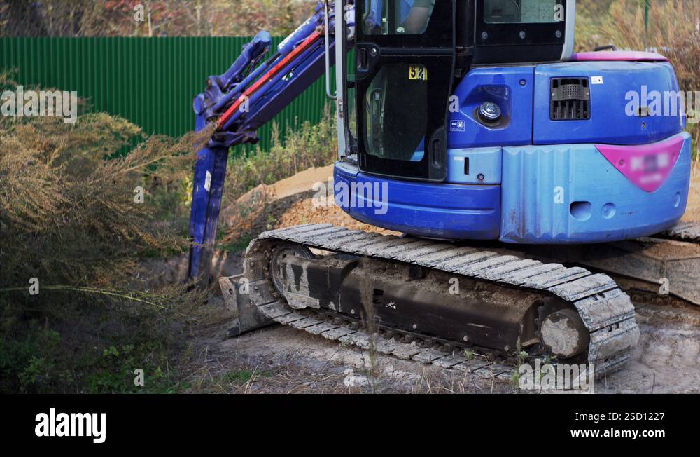Blue hydraulic digger is digging a hole for sewage caisson Stock Video ...