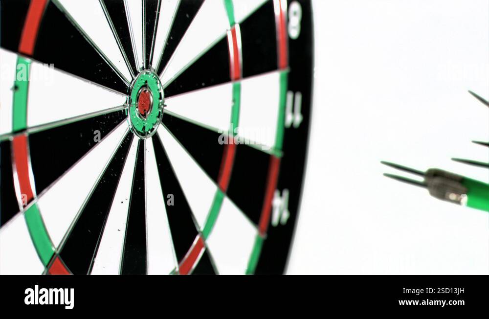 Darts grouped together in super slow motion being thrown on a dart ...