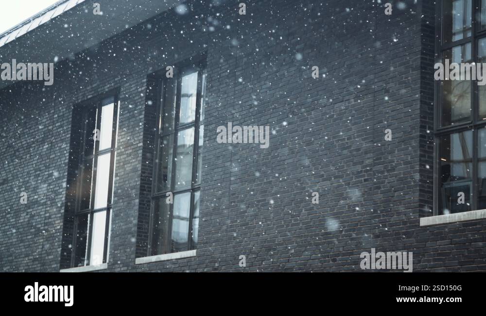 Snow Falling in front of Brick Building Stock Video Footage - Alamy