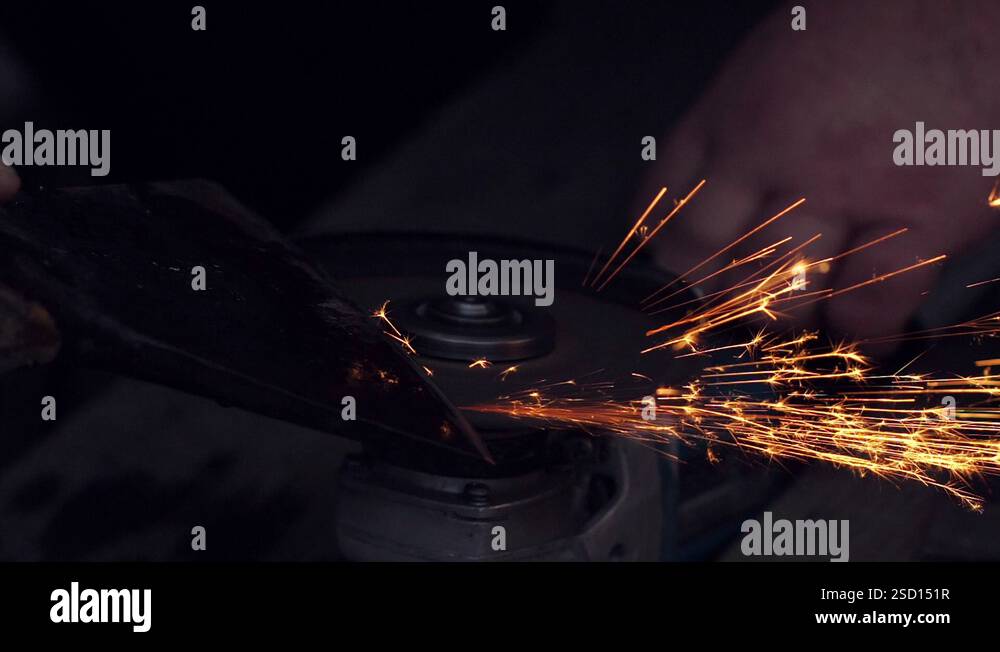 Man sharpen axe with grinder in the dark with flying sparks Stock Video ...