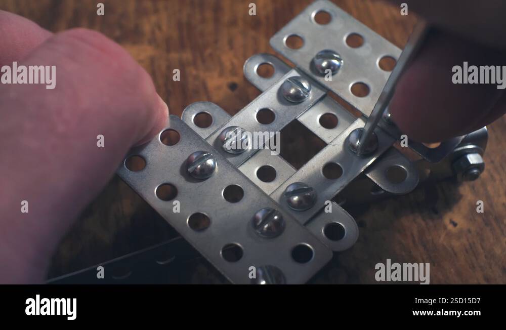 metal parts connect.hand tightens the bolt with a special screwdriver ...