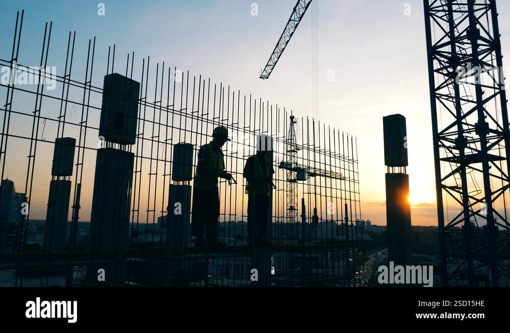 Men work on a construction site on a sky background Stock Video Footage ...
