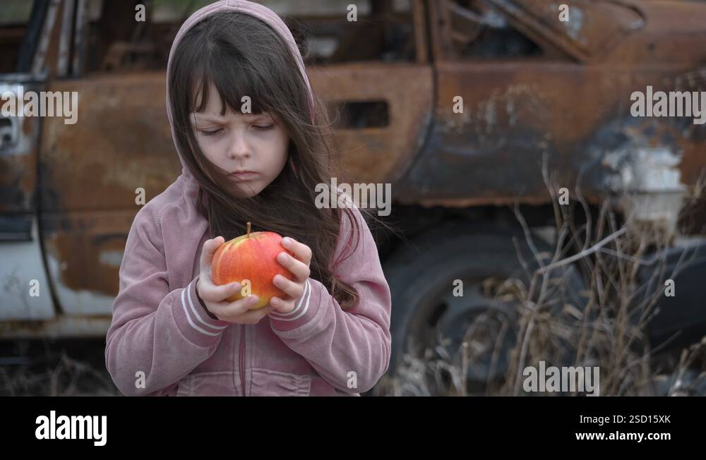Homeless child with an apple Stock Video Footage - Alamy