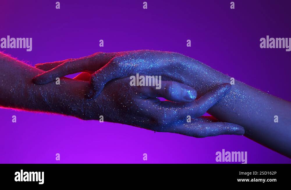 Neon 70s style vivid light. Two male and female hands in sparkles ...